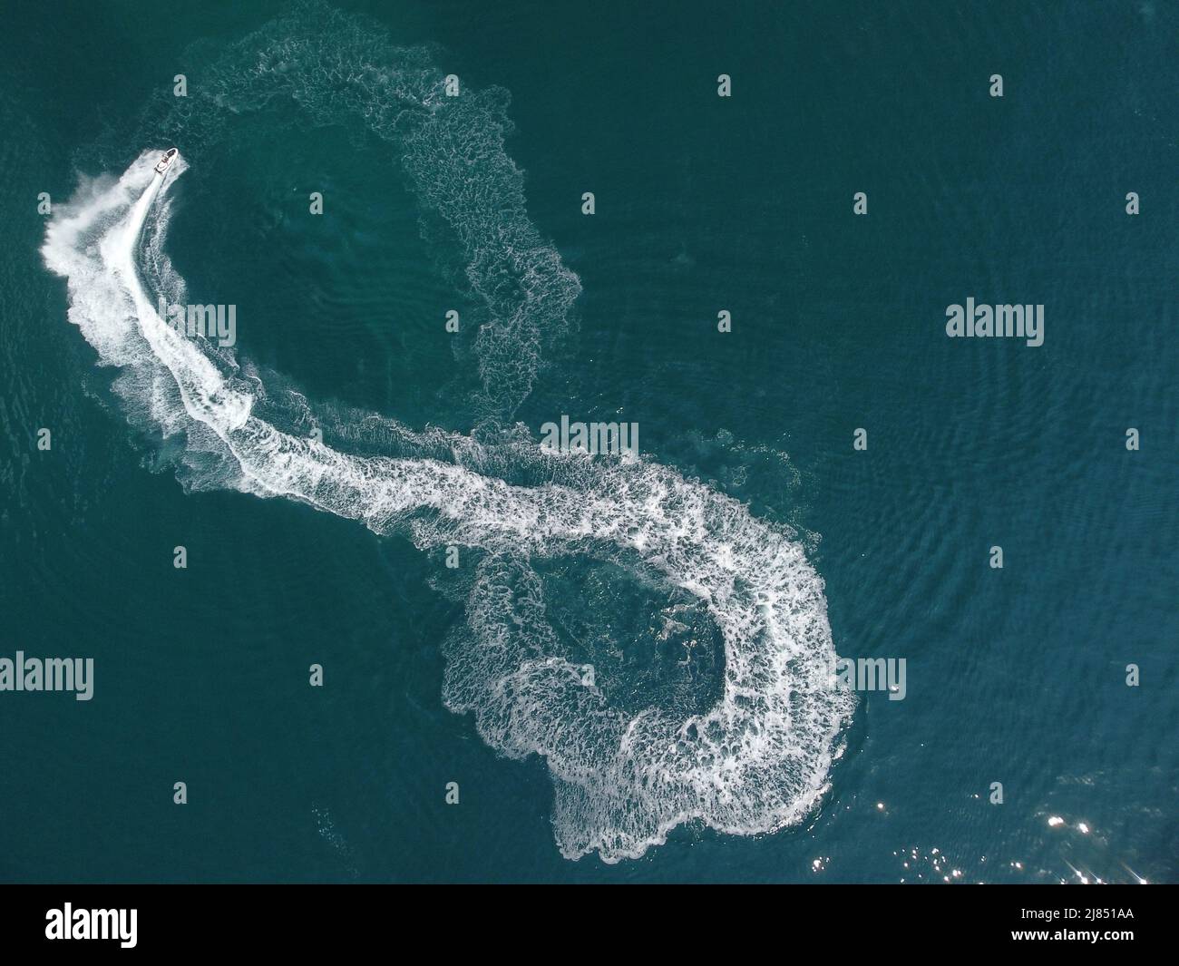 Aerial top down view of water foam trace with nice deep blue shade of ...