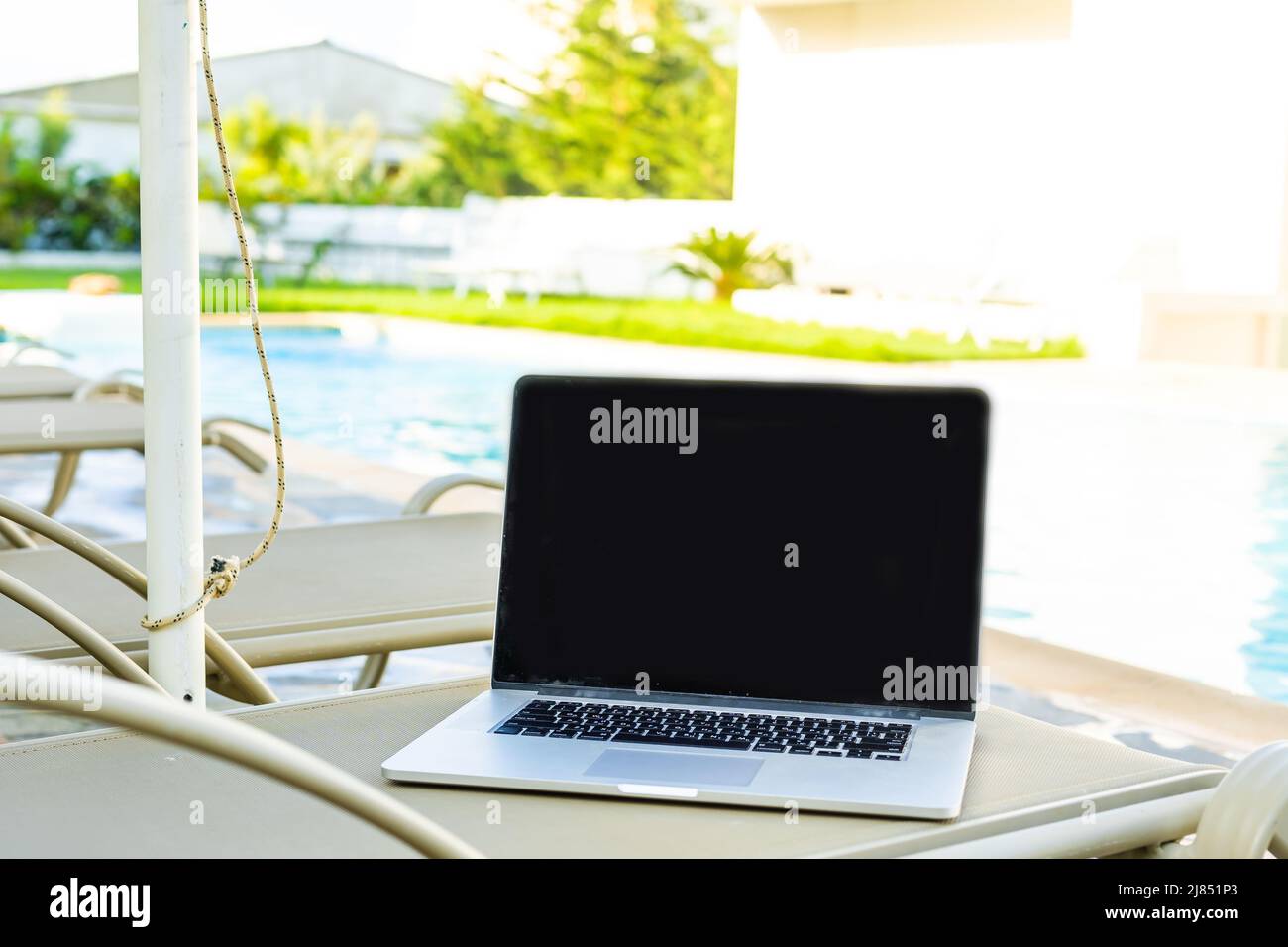 laptop on a sun lounger by the pool Stock Photo - Alamy