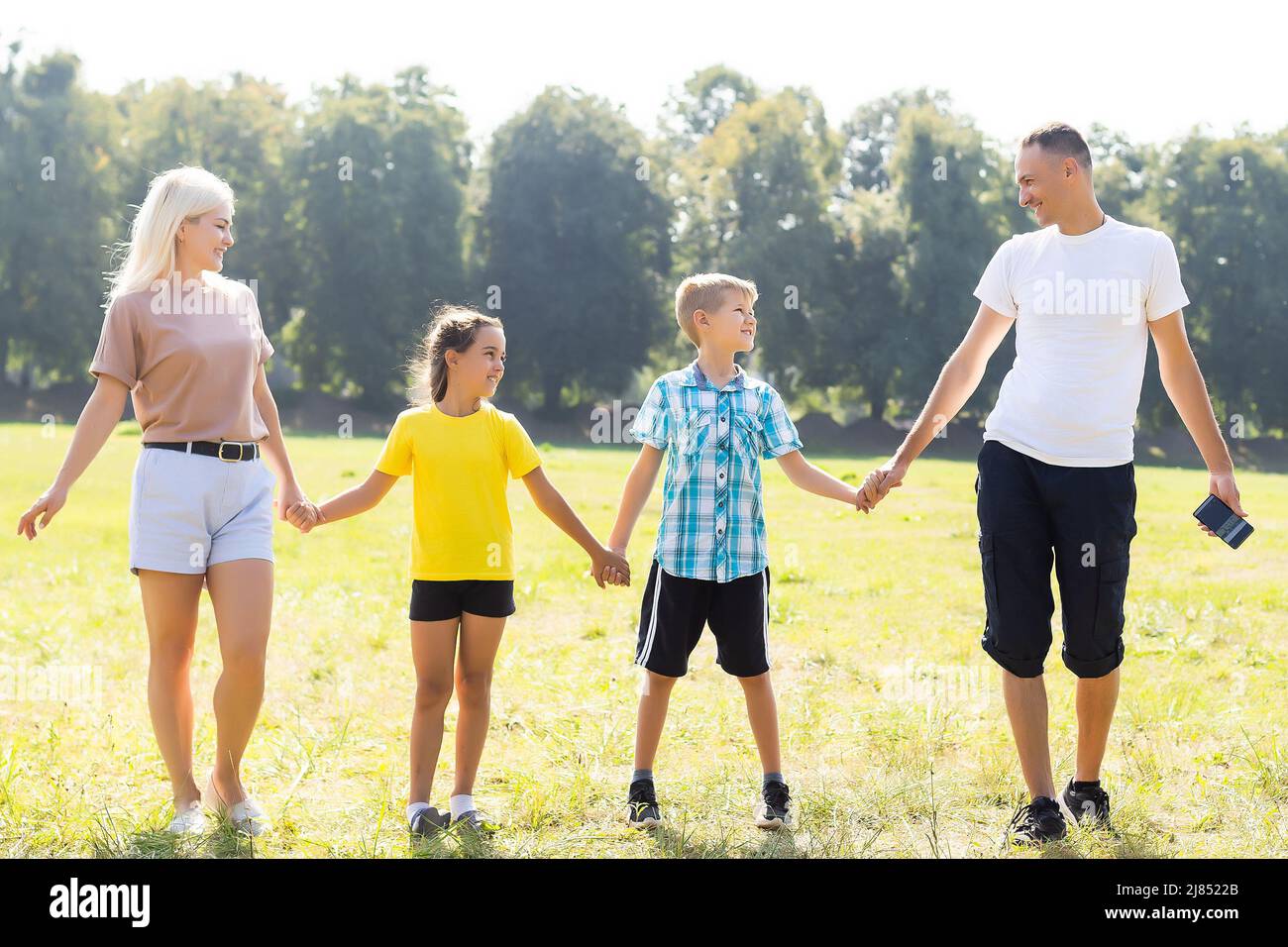 Happy family enjoying life together at meadow outdoor Stock Photo - Alamy