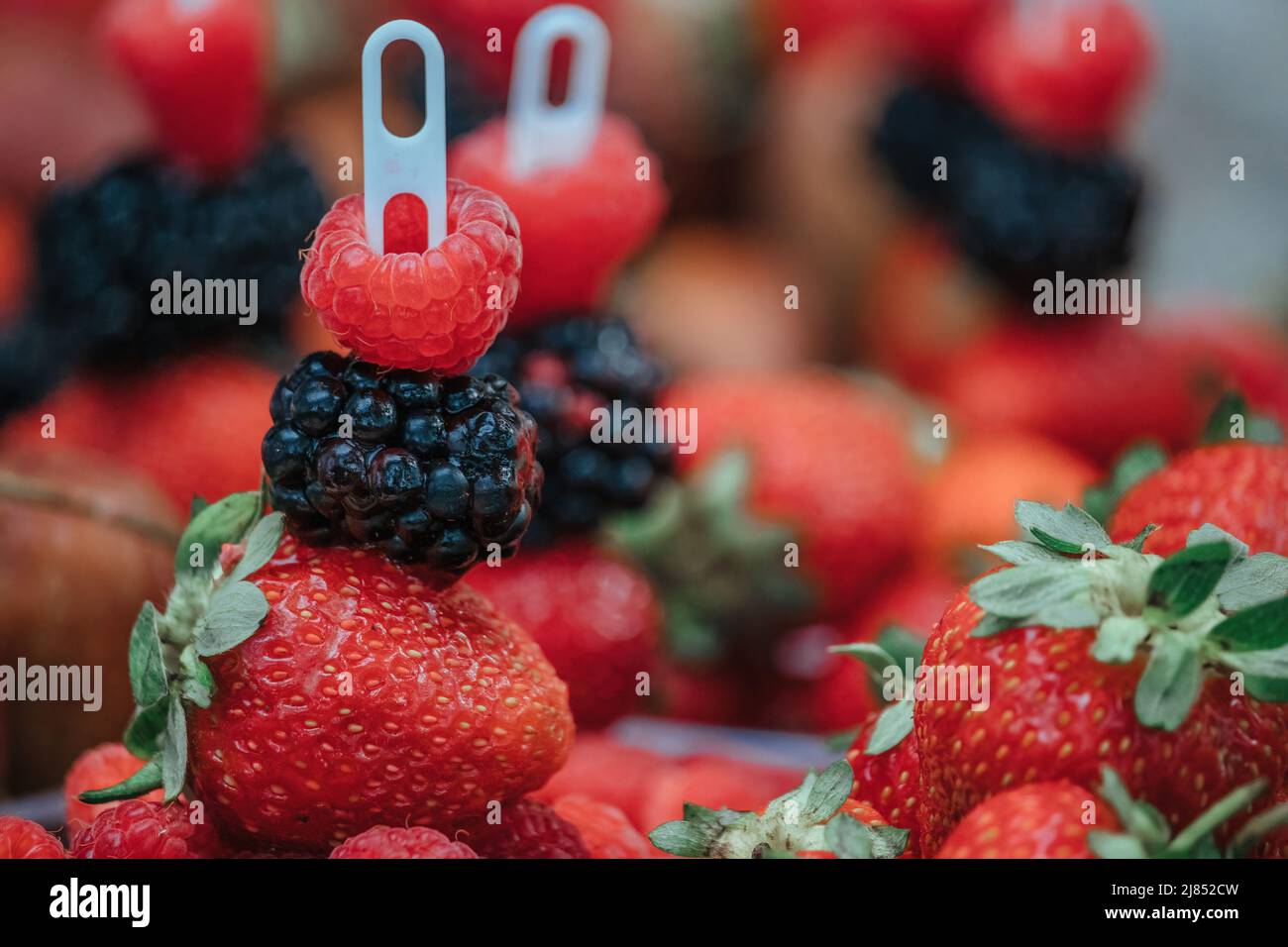 Selective focus. fresh strawberries, raspberries and blackberries in a ...