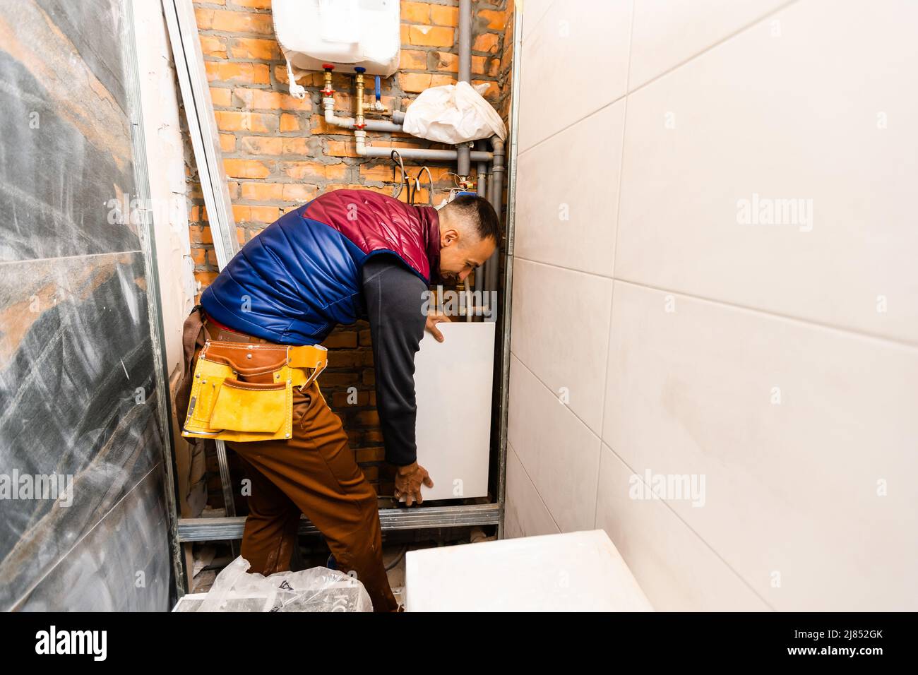 industrial tiler builder worker installing floor tile at repair ...