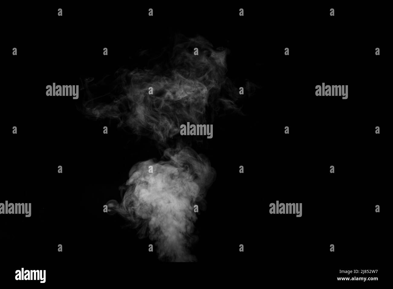 Curly white steam rising up and splashing water scattering in different ...