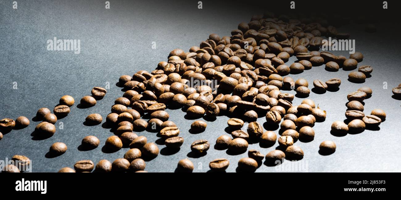 many flying coffee beans on black background Stock Photo - Alamy
