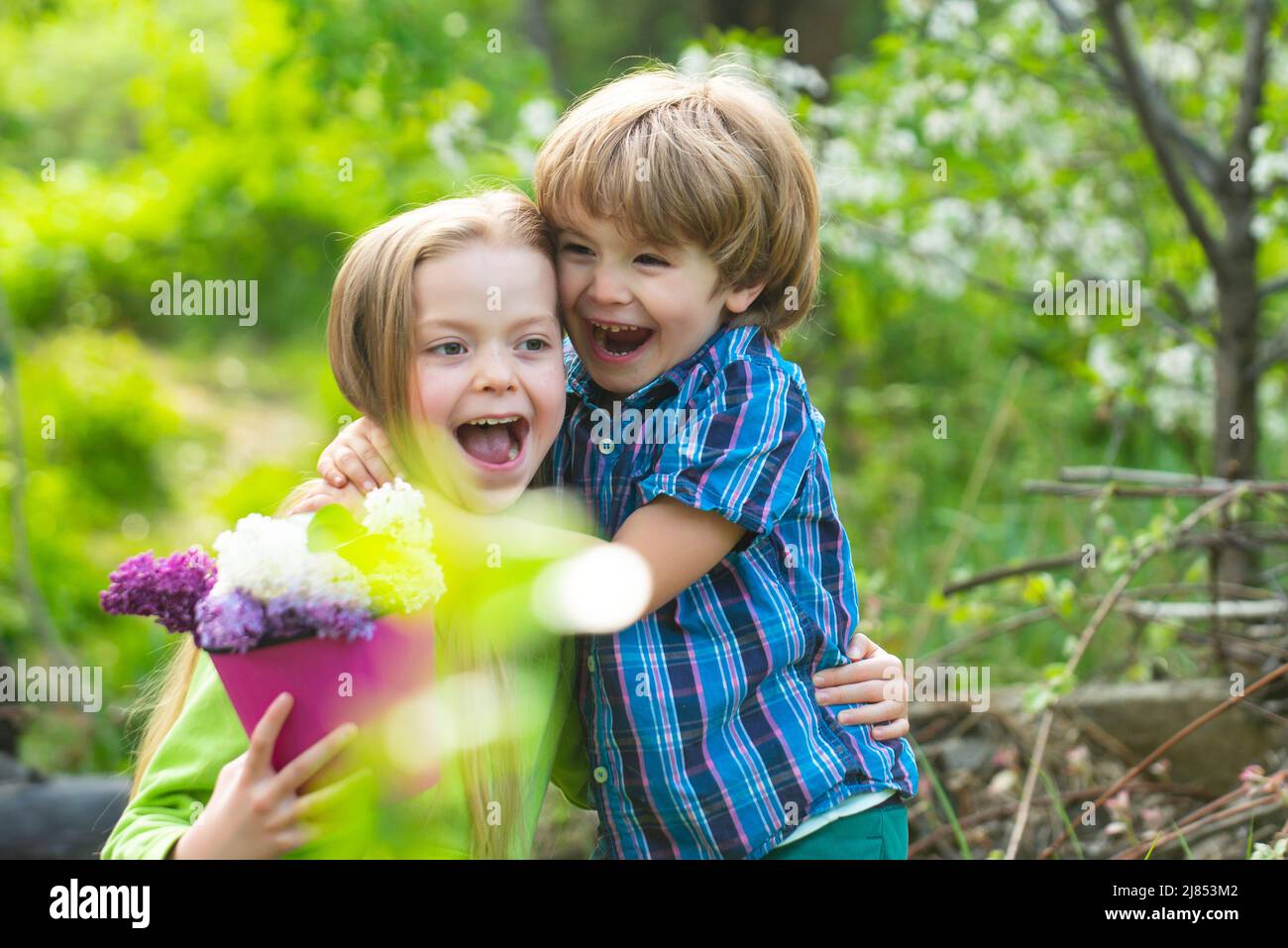 Excited little boy hugging shy girl, toddler boy embracing depressed ...