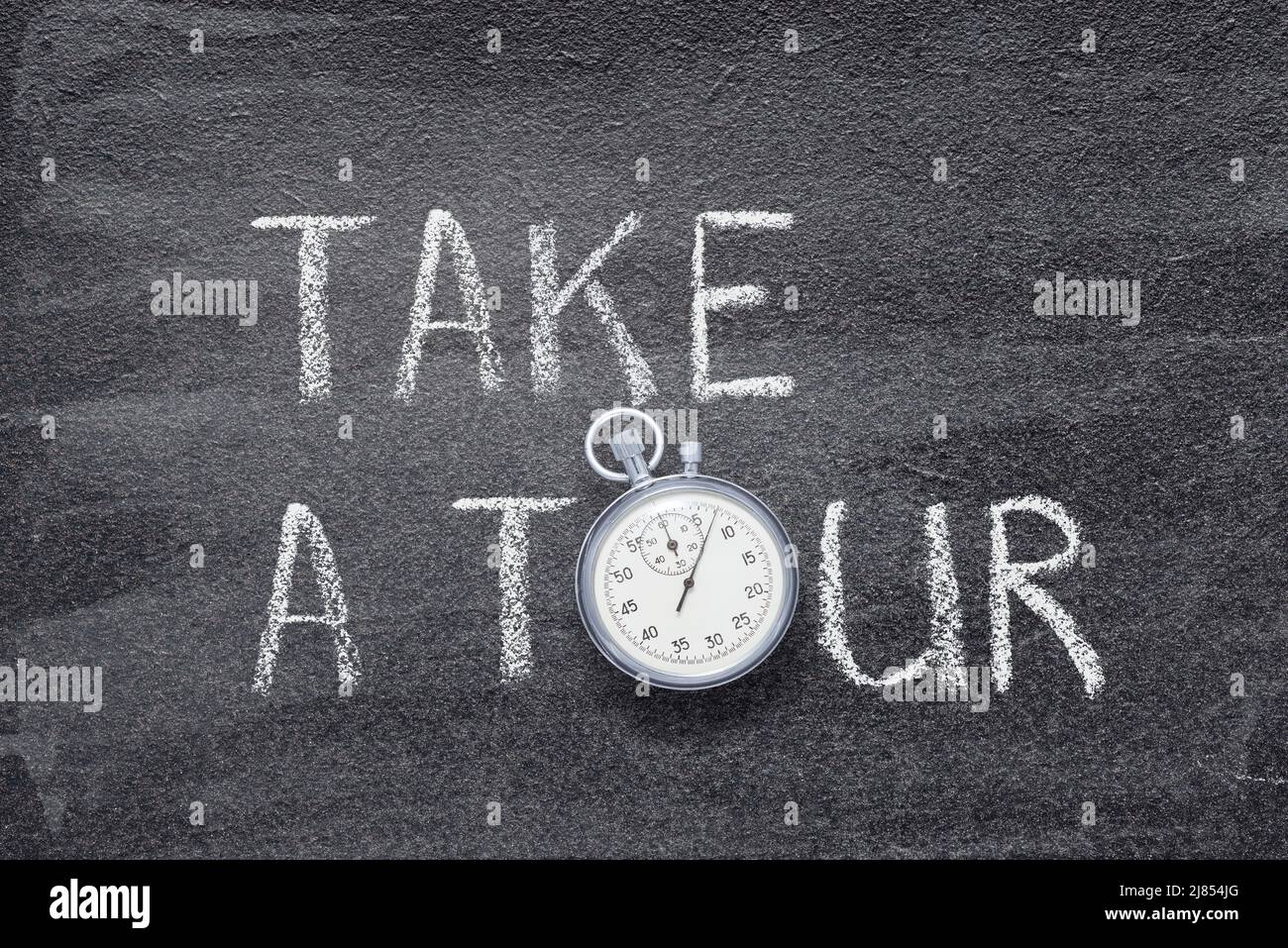 take a tour phrase written on chalkboard with vintage precise stopwatch ...