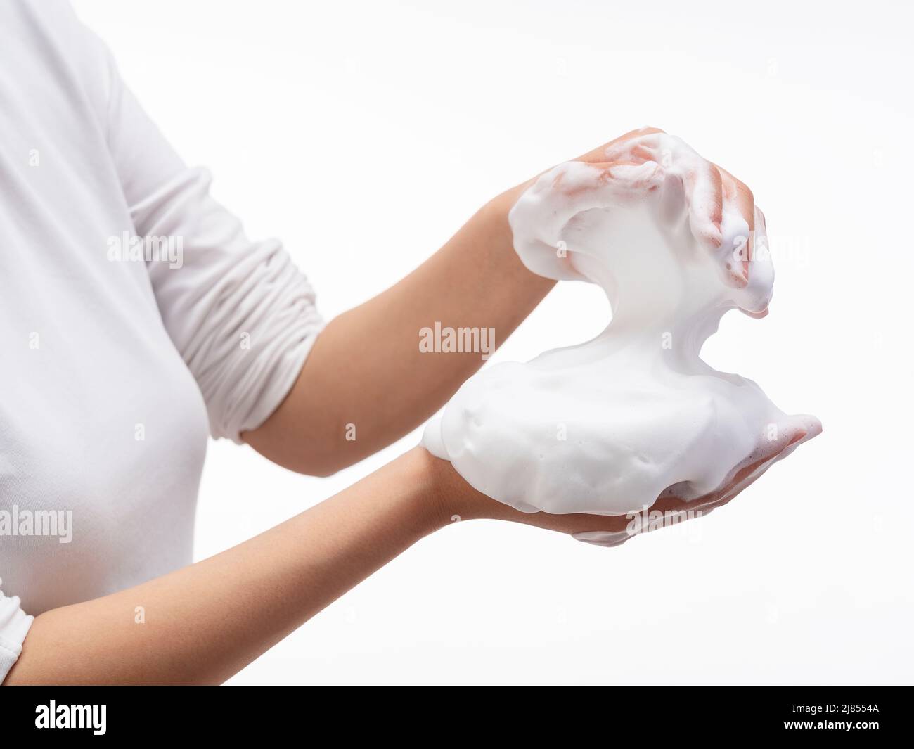Female holding soap bubbles on white background. Hands with white ...