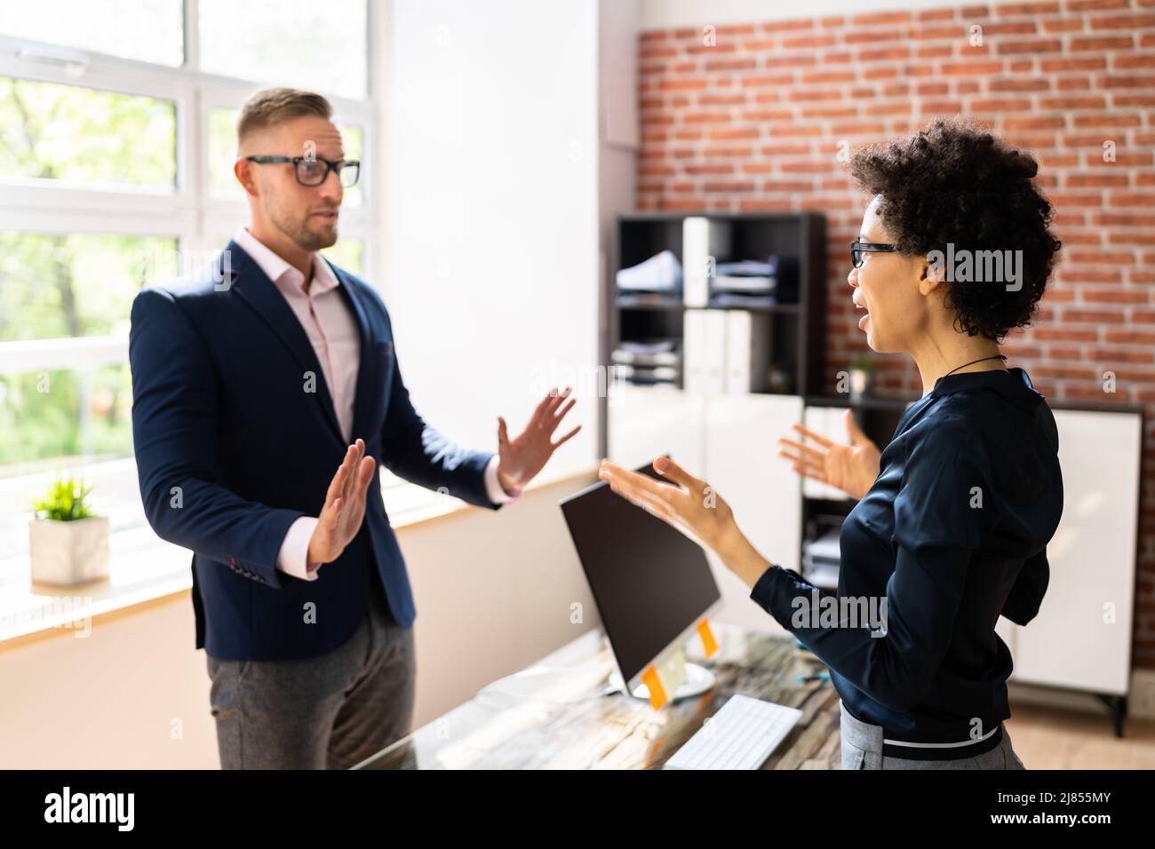 Side View Of Business People Quarreling At Desk In Office Stock Photo ...