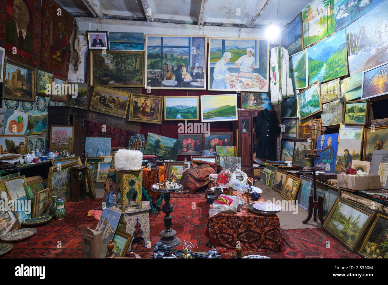 A vendor selling old, USSR, Communist era paintings. At the Yangiobod ...