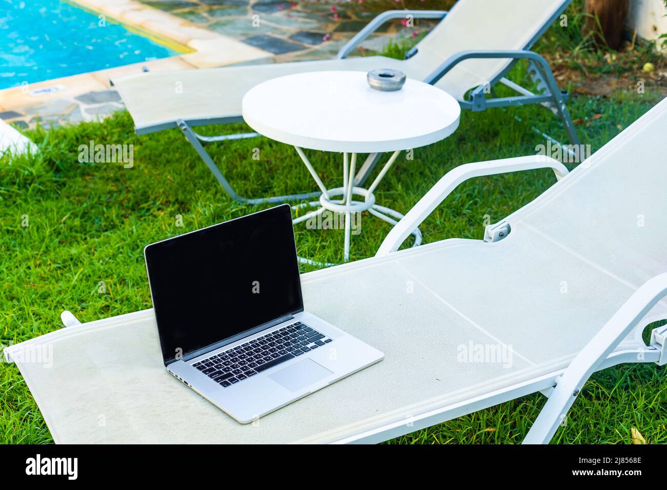 laptop on a sun lounger by the pool Stock Photo - Alamy