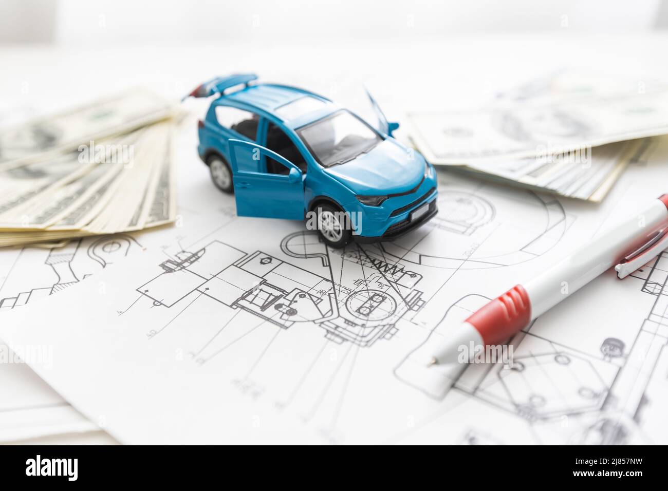 small car model and blueprint sheets Stock Photo - Alamy
