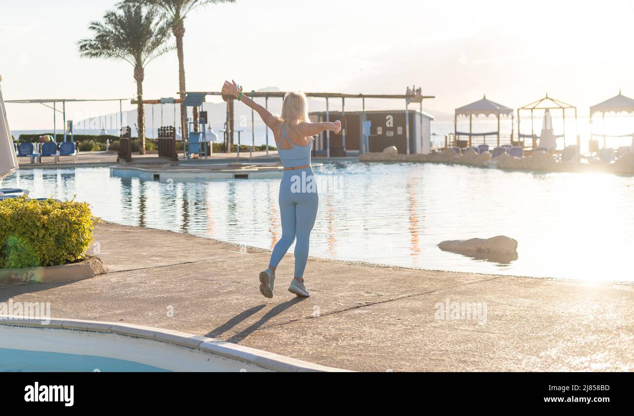Good morning with yoga meditating on sunrise background. Active woman ...
