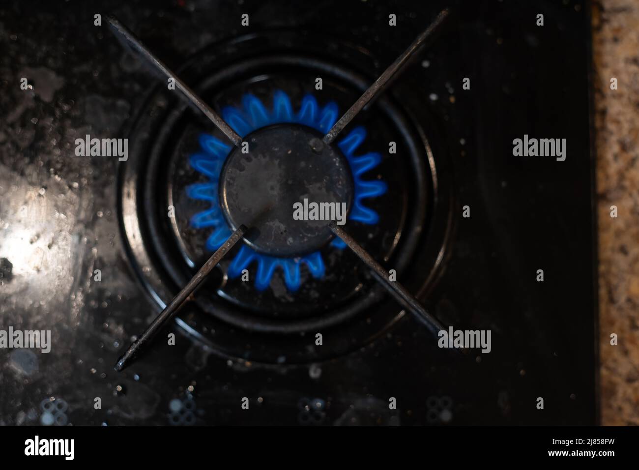 Closeup shot of blue fire from domestic kitchen stove top. Gas cooker ...