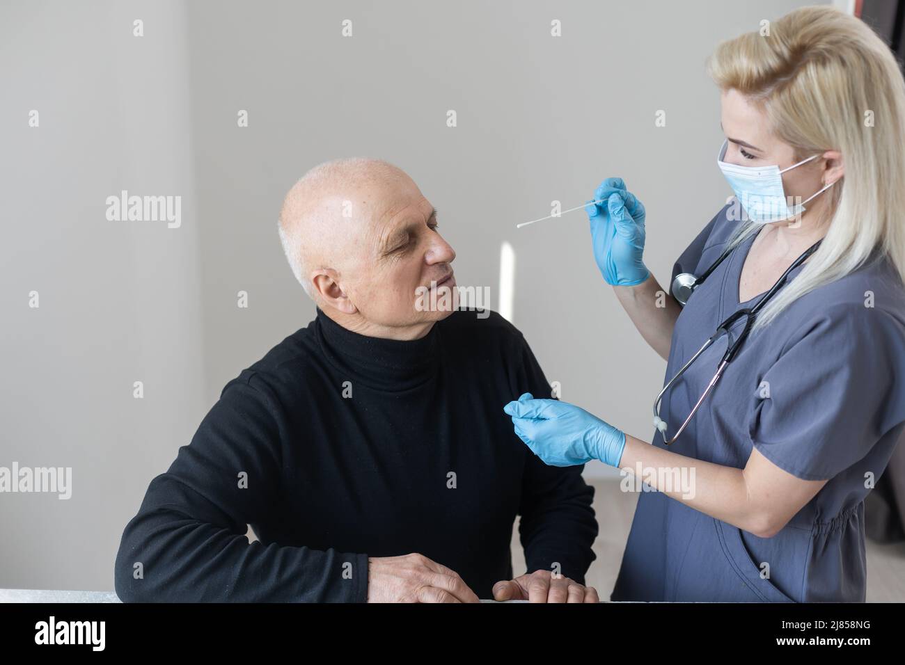 Doctor using nose swab test coronavirus COVID-19 with senior elderly ...