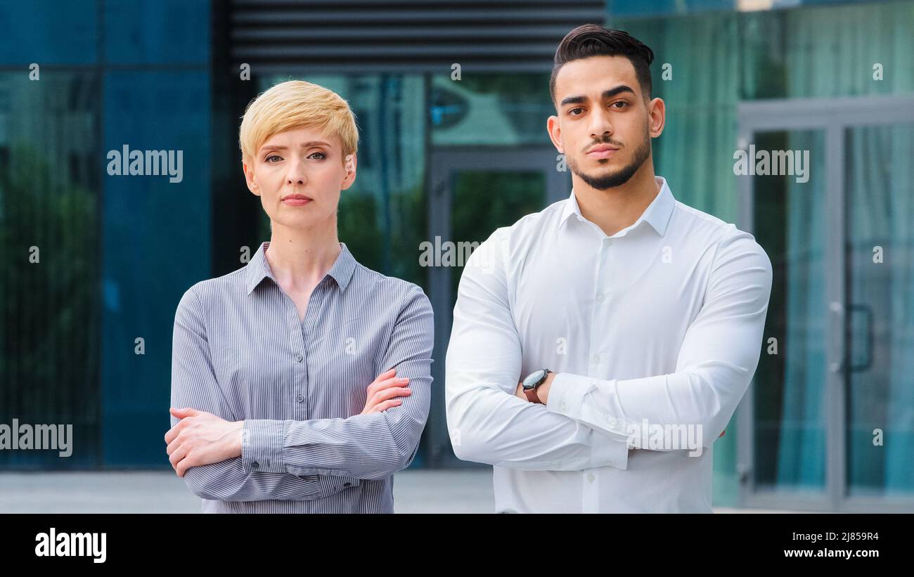Multiracial couple of business colleagues serious co-workers caucasian ...