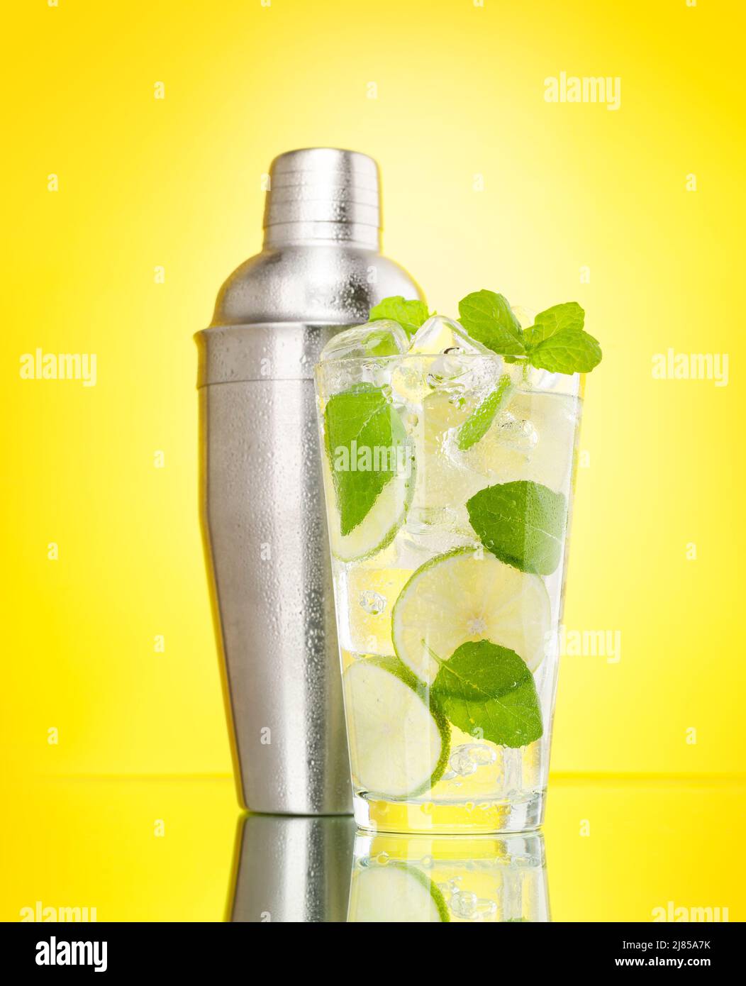 Mojito cocktail and cocktail shaker on yellow background Stock Photo ...