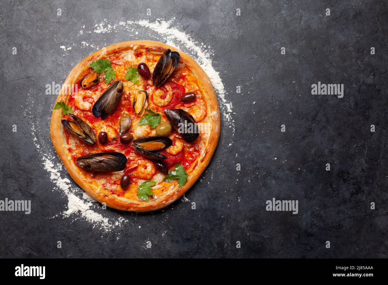 Italian cuisine. Seafood pizza. Flat lay on stone table with copy space ...