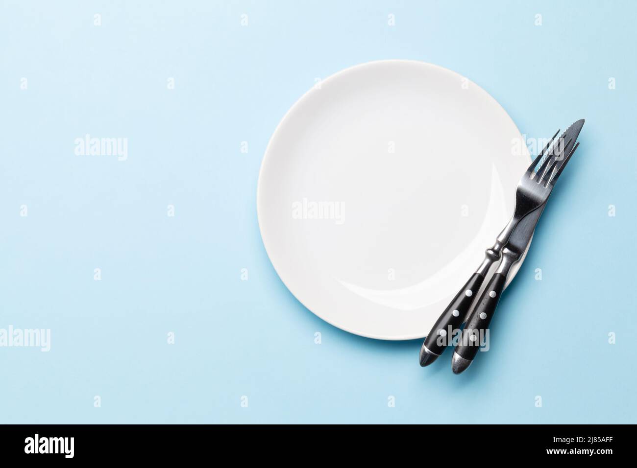 Empty plate and silverware. Top view flat lay with copy space. Template ...