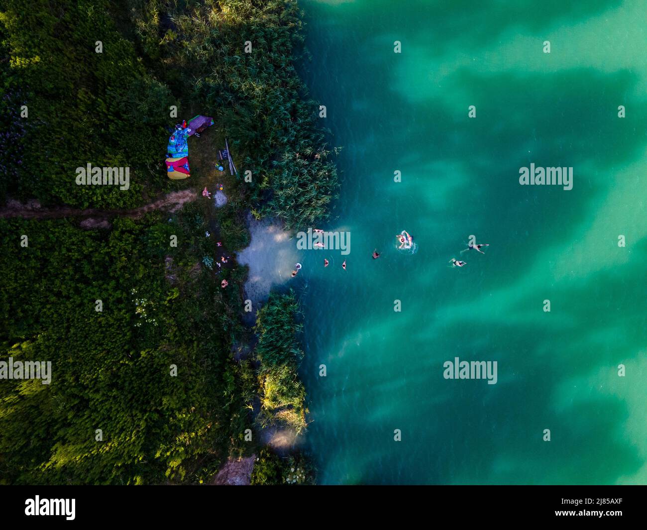 overhead view of leak beach blue water. people having fun swimming ...