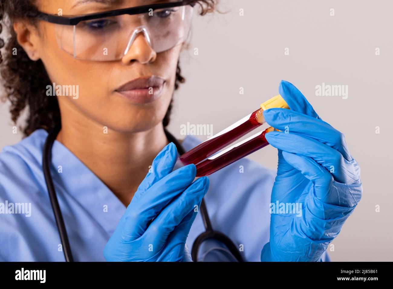 African american mid adult female doctor wearing protective eyewear and ...