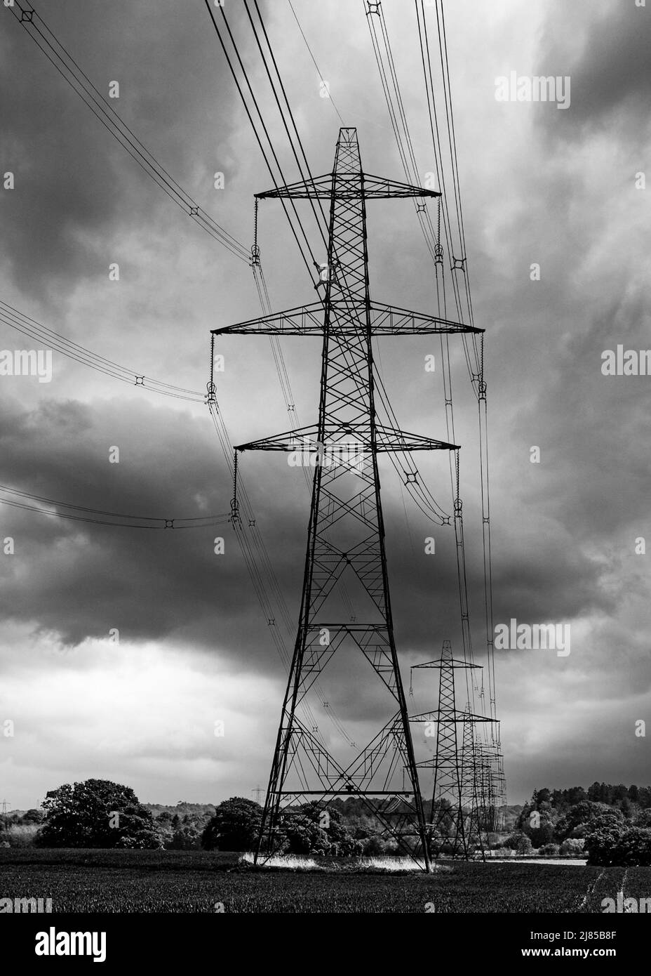 Power cable pylons in the Sussex countryside in black and white Stock ...