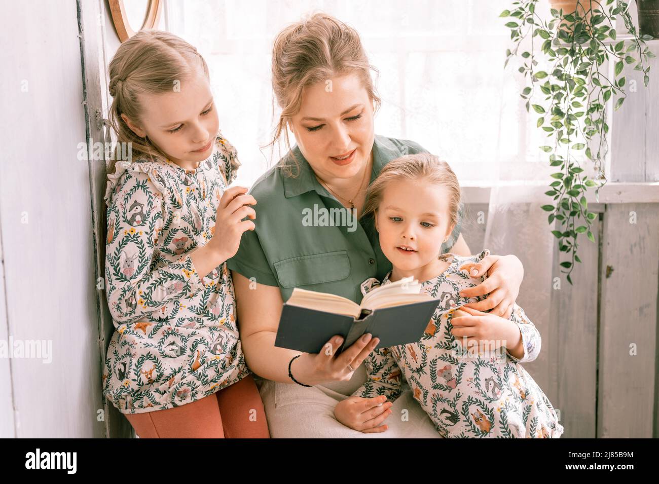 happy family mother with cute little kids daughters girls have fun ...