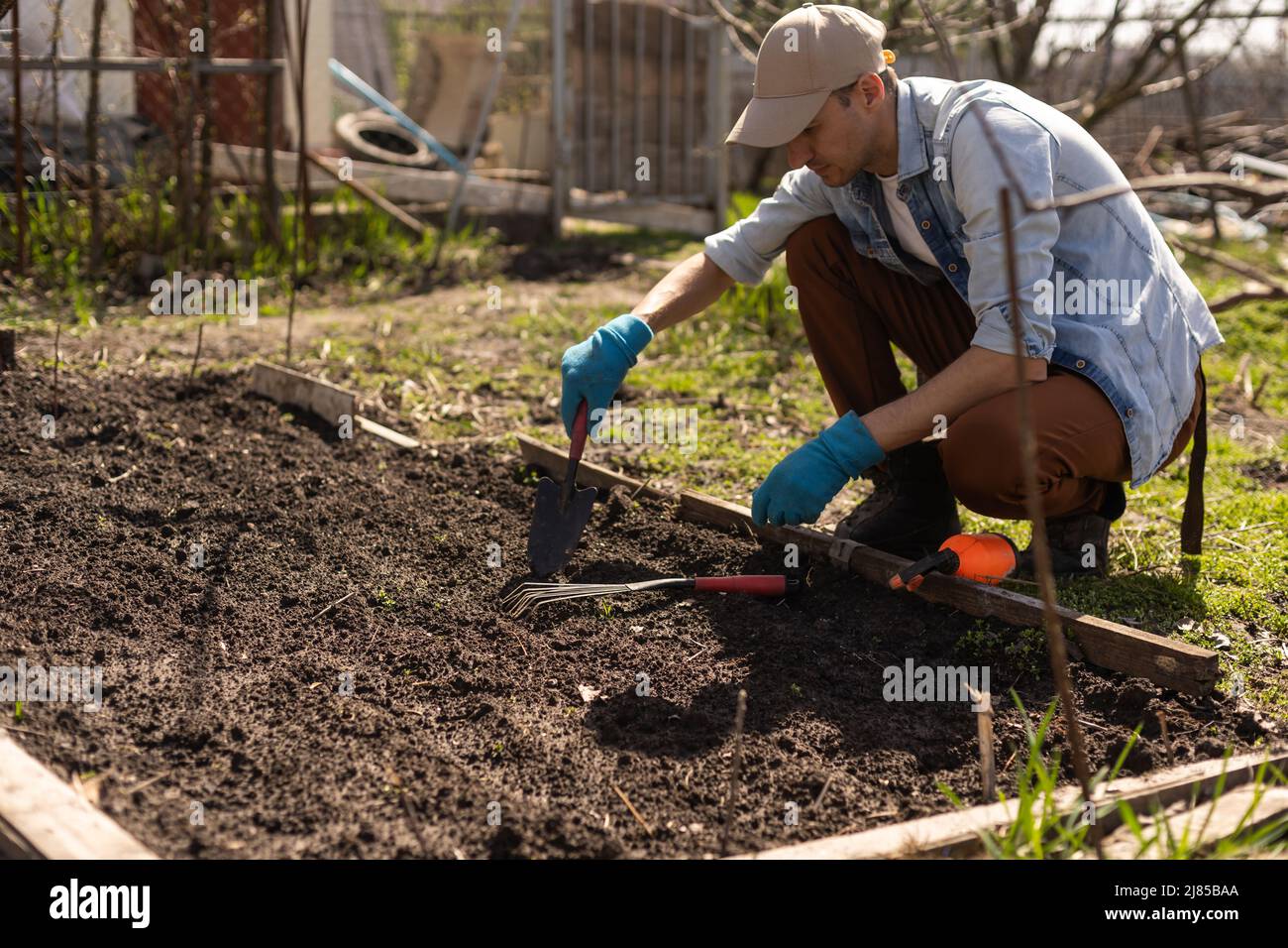 Farmer planting in the vegetable garden Stock Photo - Alamy