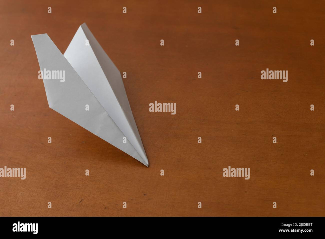 paper airplane on an old wooden table Stock Photo - Alamy