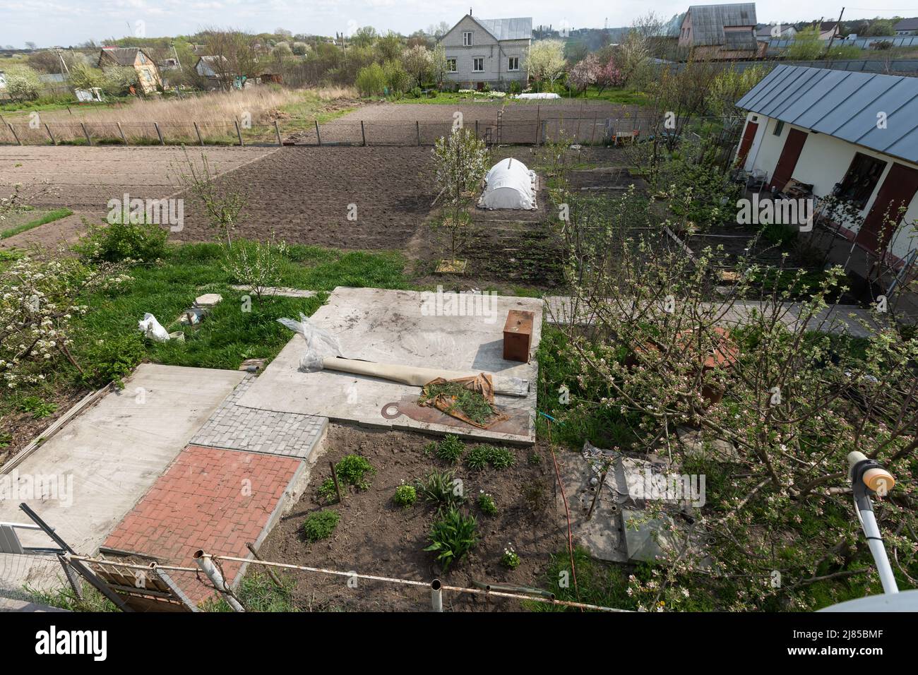 Homemade Old Greenhouse on a small farm next to the house. Rural life ...