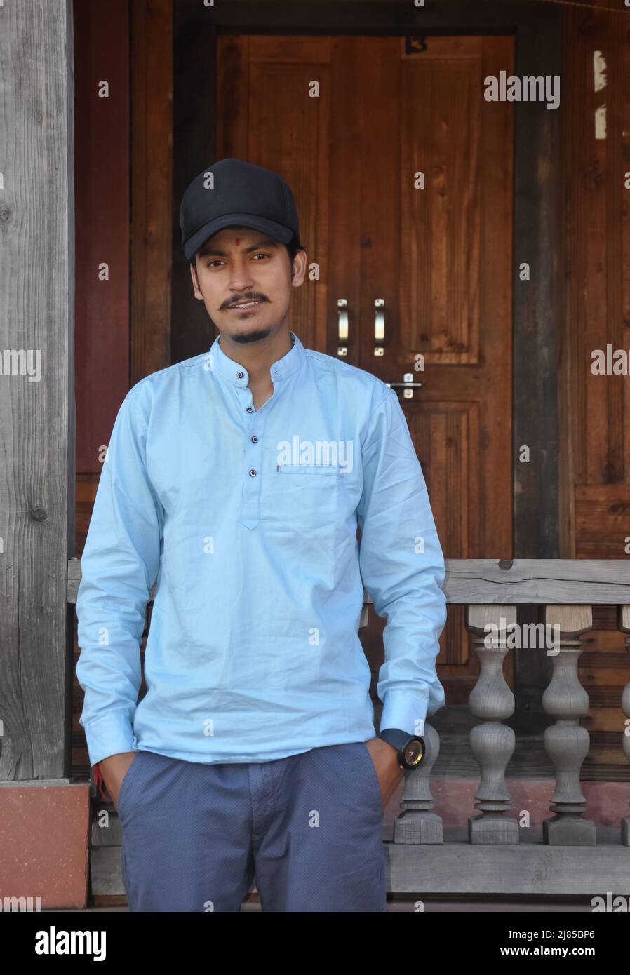 Front view of a north Indian young guy wearing cap backwards and posing ...