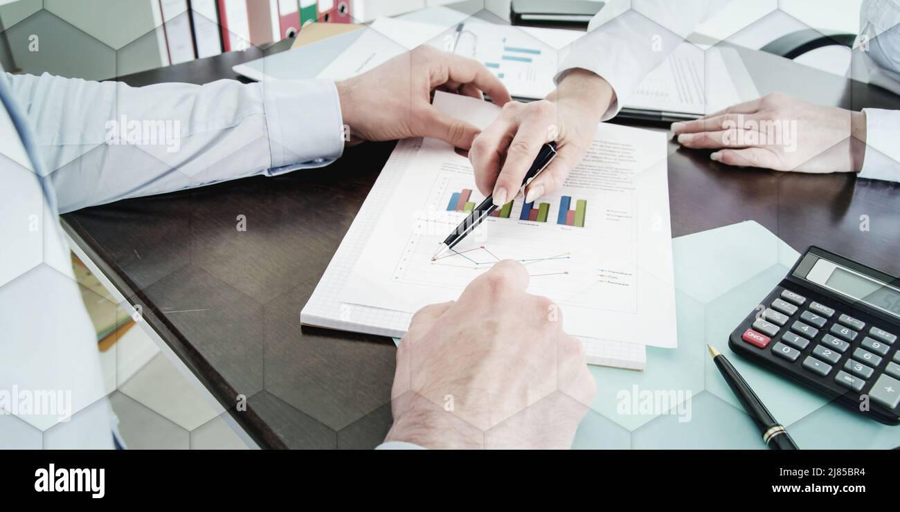 Two business people analyzing charts, geometric pattern Stock Photo - Alamy