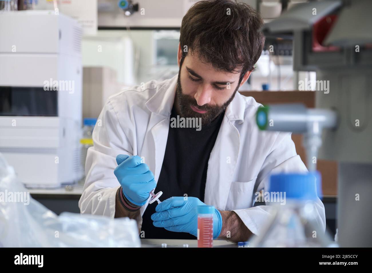 Young male researcher working in a real laboratory Stock Photo - Alamy
