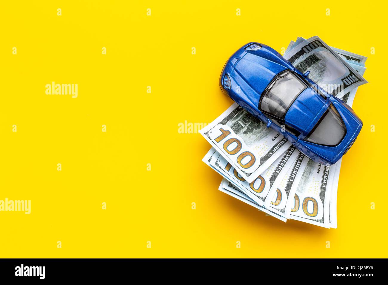 Money to buy or rent a car concept. Toy car with money cash Stock Photo ...