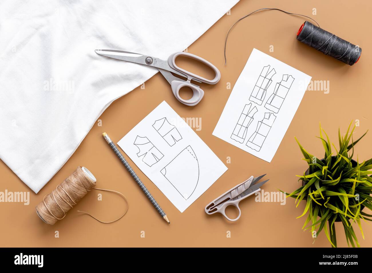 Sewing clothes knitwear in workshop with dress patterns with fabric ...