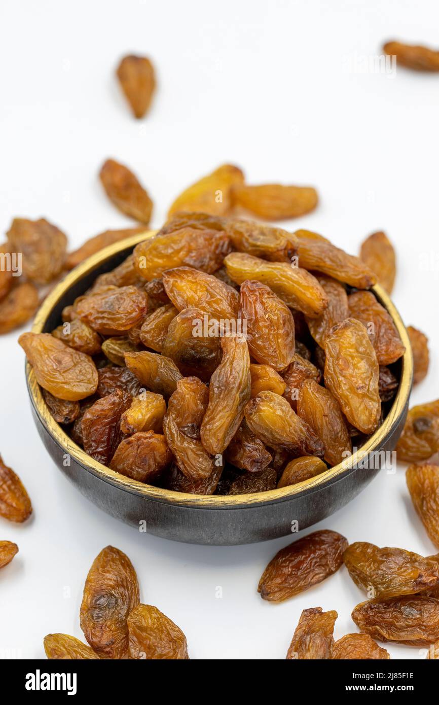 Dried raisins on a white background. Raw grapes and raisins. Healthy ...