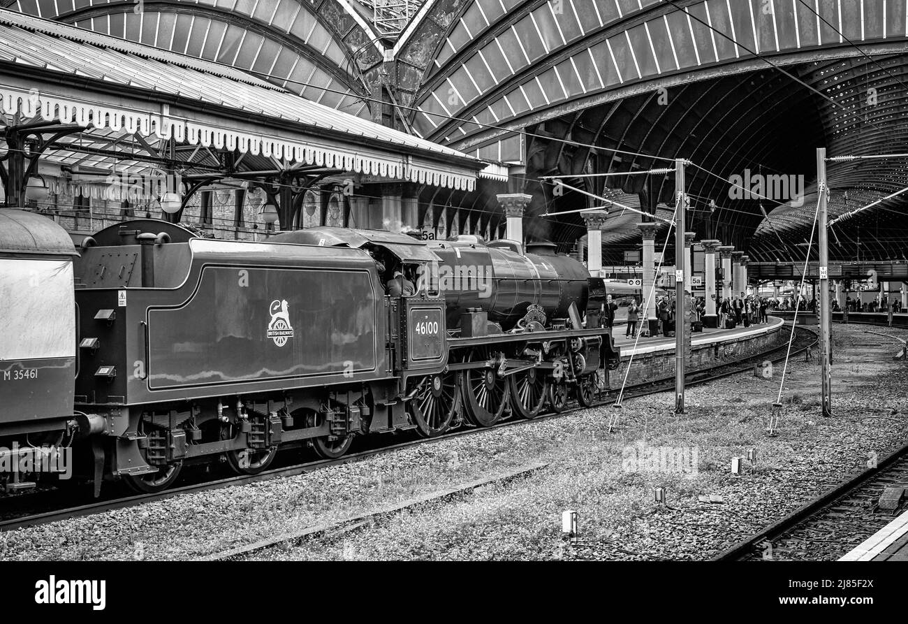 Old steam train arrives at a historic railway station platform ...