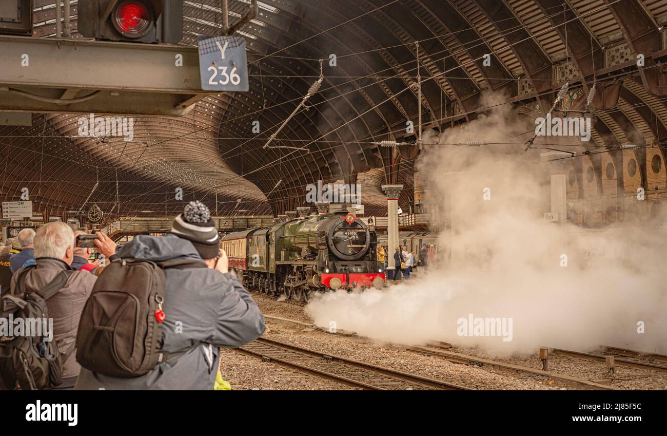 Old steam train stands at a historic railway station platform getting ...