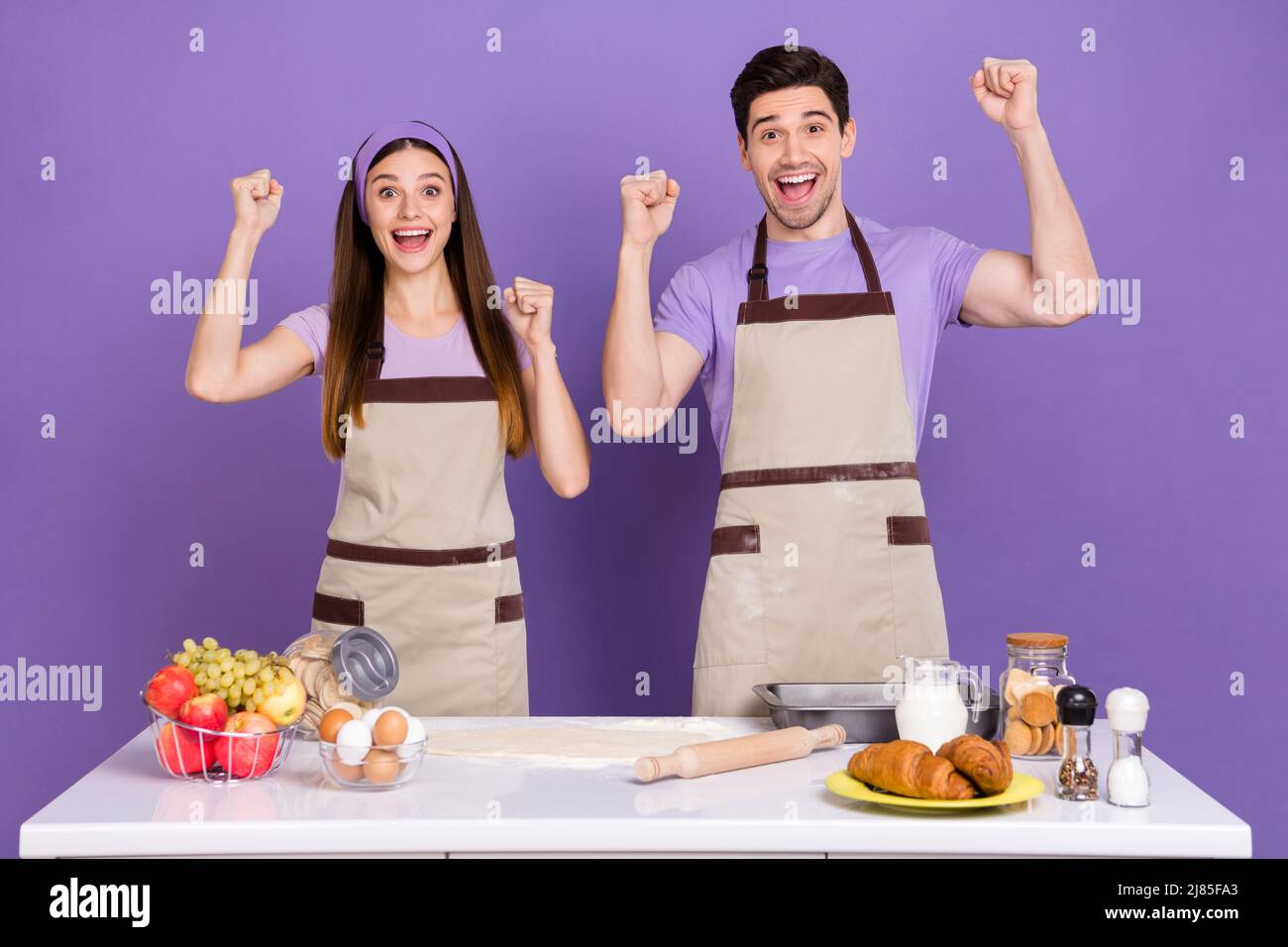 Portrait of two delighted excited crazy partners raise fists celebrate ...