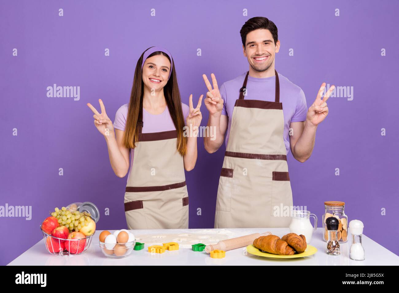 Photo of two positive funny partners hands fingers show v-sign isolated ...