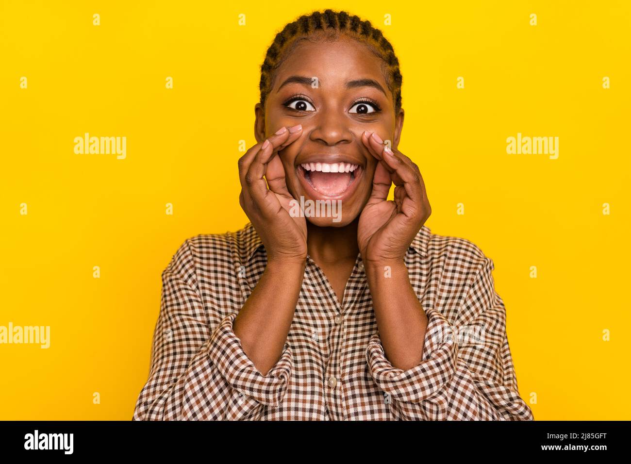 Photo of charming excited lady dressed checkered shirt arms mouth ...