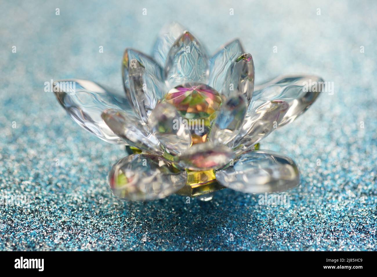 Crystal lotus on shiny blue surface. Paradise bud symbol Stock Photo ...