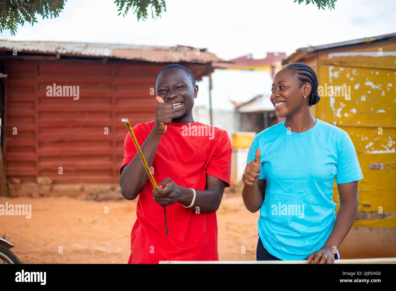 local african carpenter and his customer feeling excited at work ...