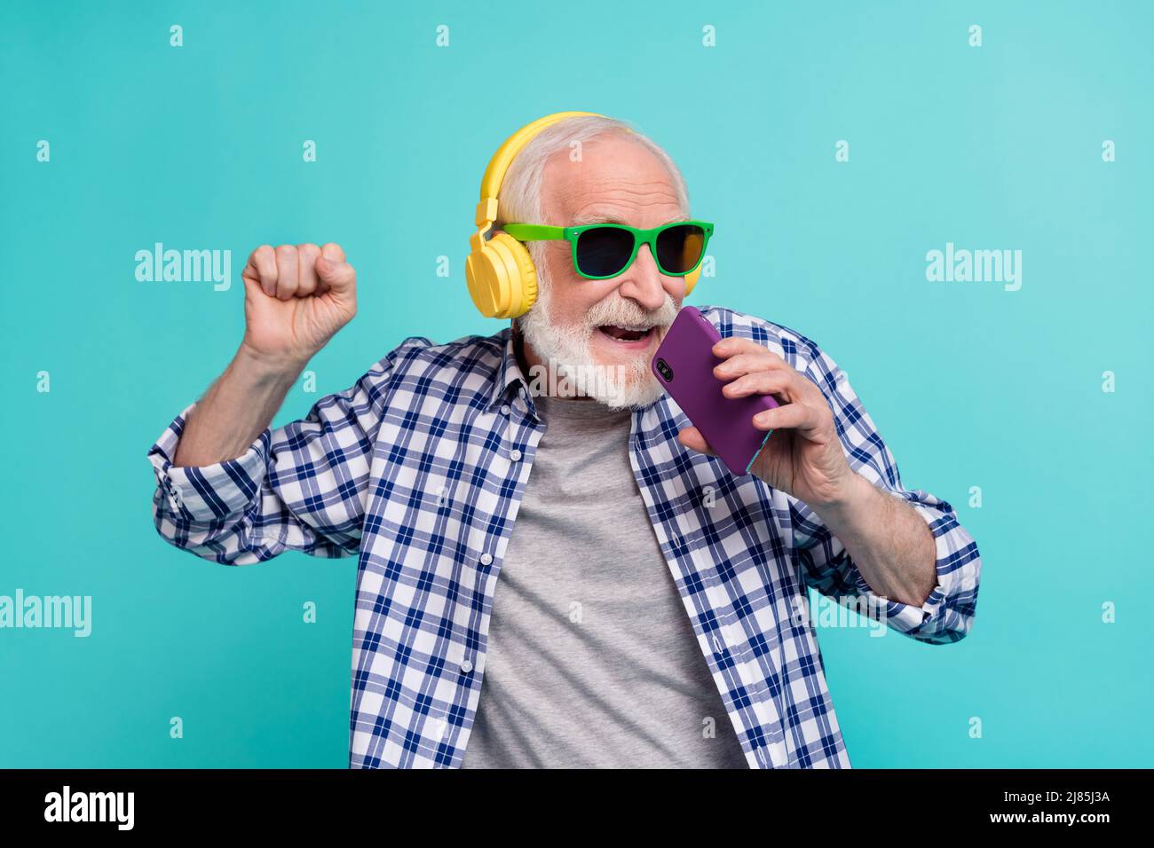 Portrait of excited crazy grandpa hold telephone singing enjoy new ...