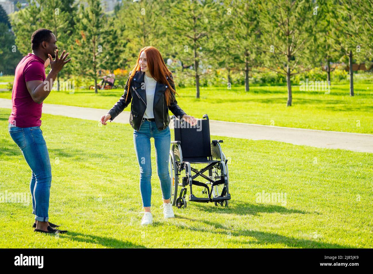 african american man helping to her redhaired ginger woman to making ...