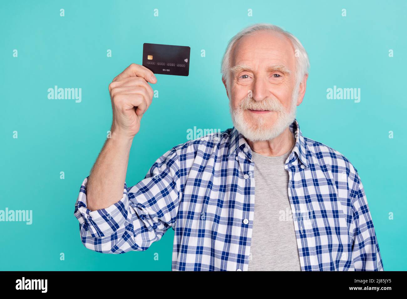 Portrait of positive friendly grandpa hold showing plastic debit card ...
