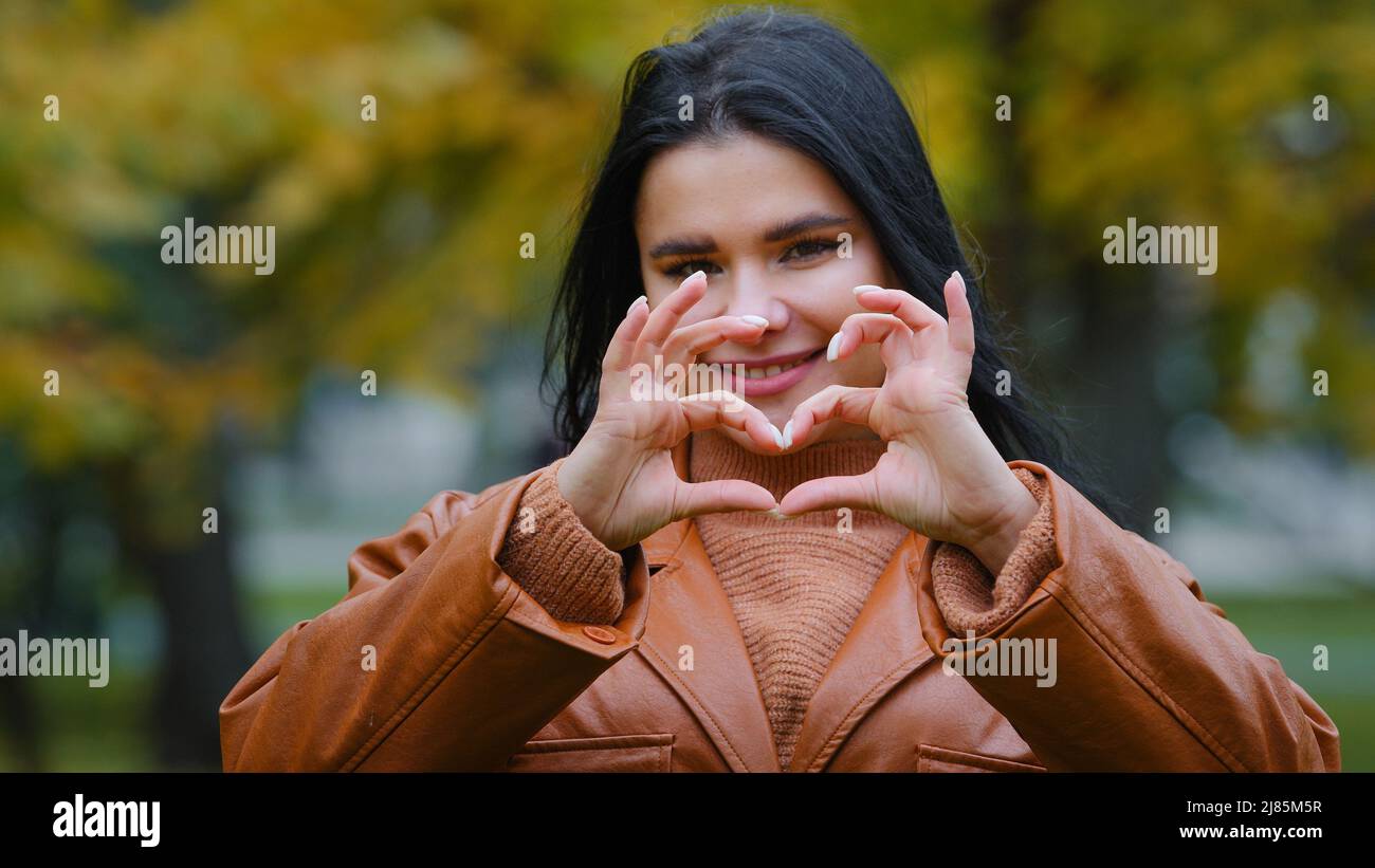 Head shot young happy overweight woman stands outdoors smiling hispanic ...