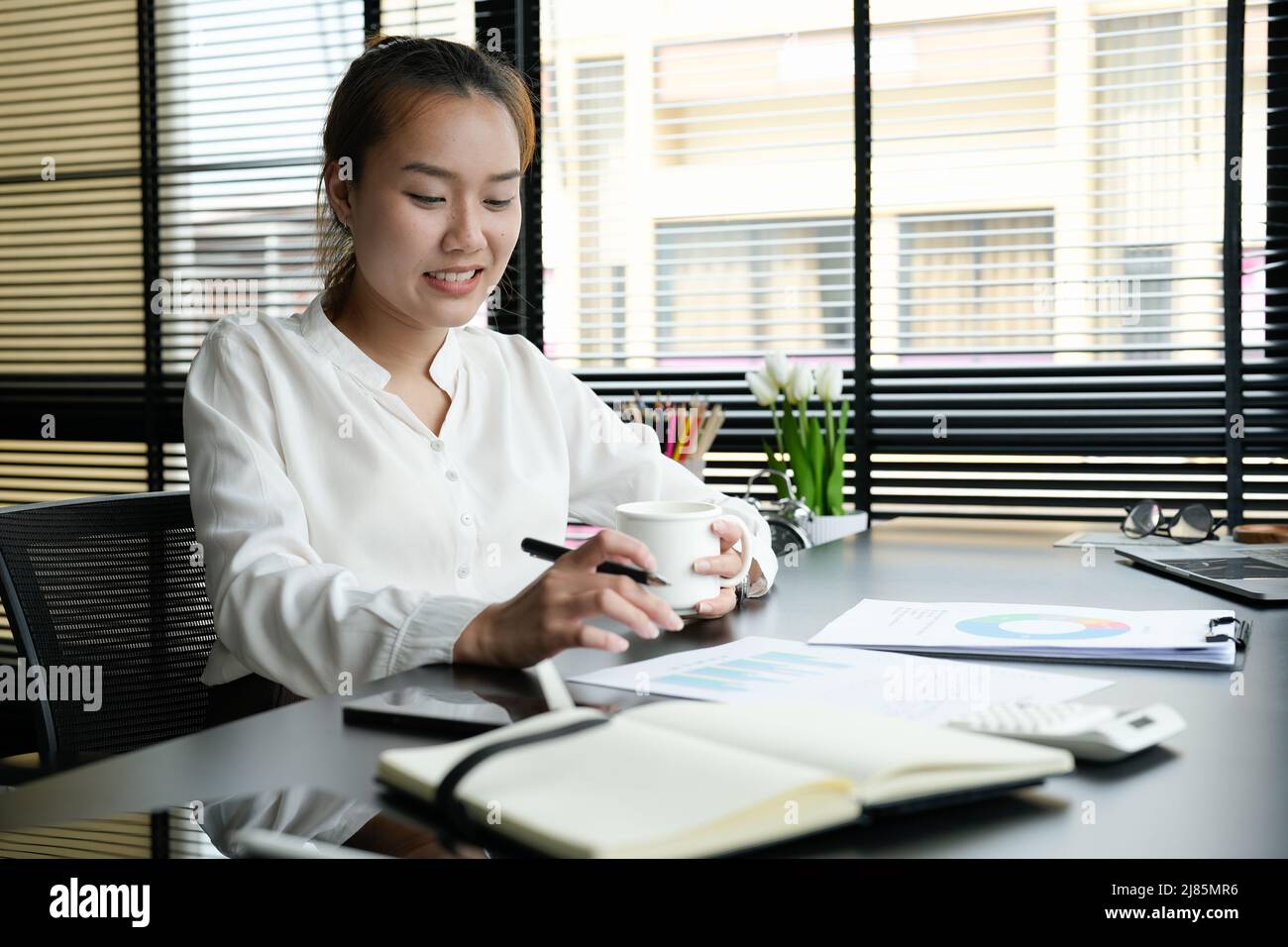 Business accountant asian woman analysis financial report at her office ...