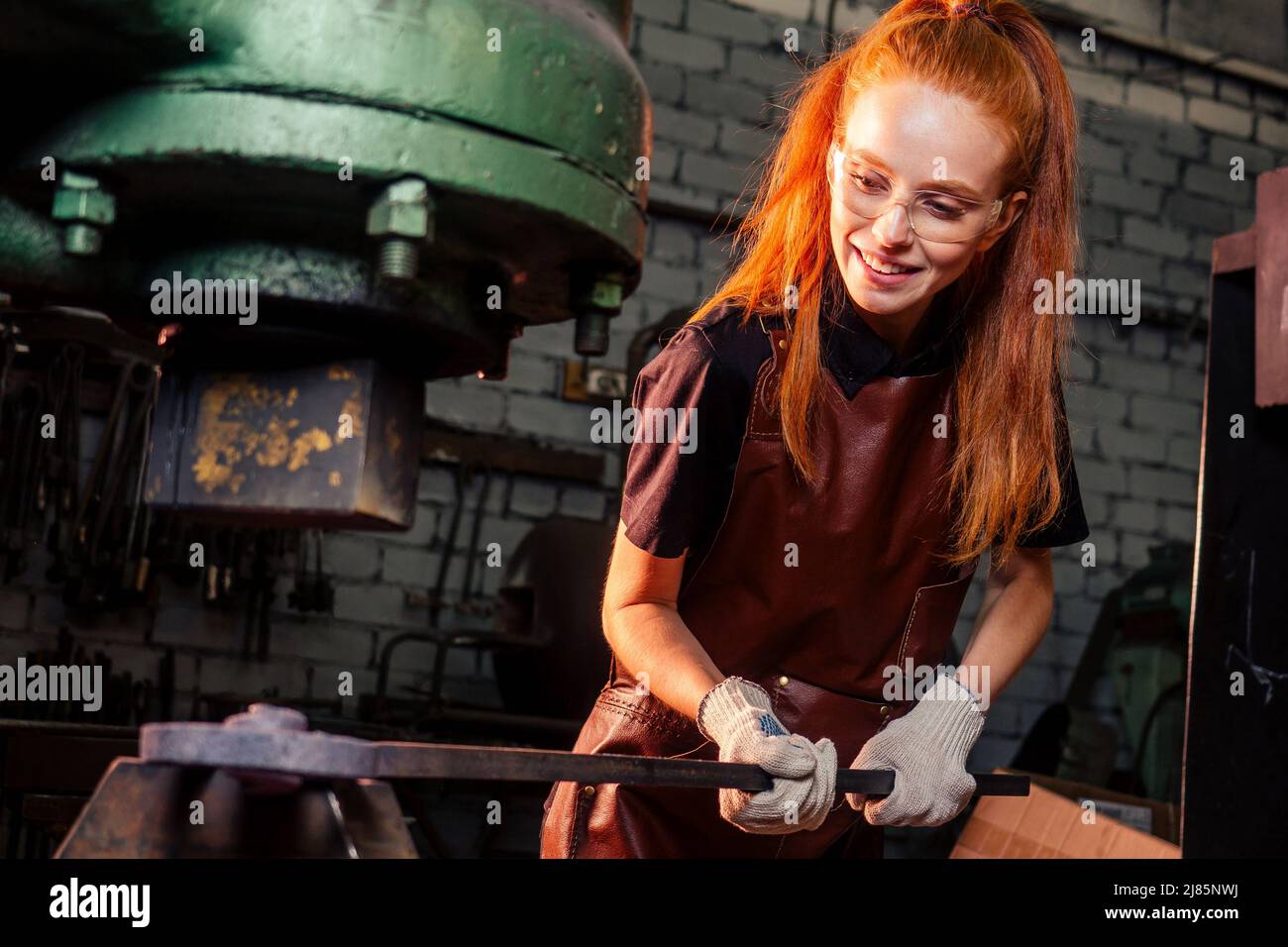 redhead ginger woman blacksmith portrait in workshop Stock Photo - Alamy