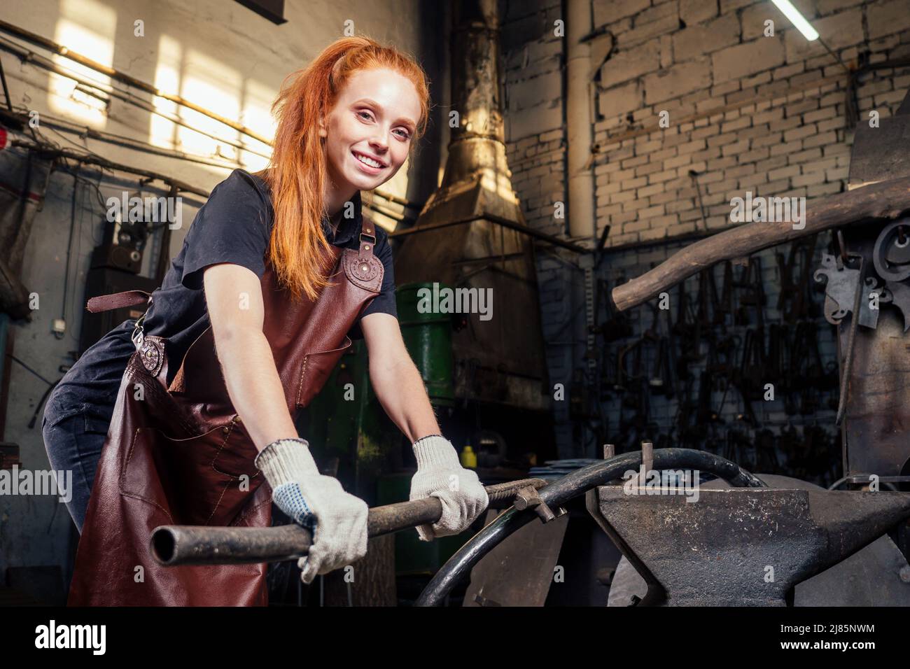 redhead ginger woman blacksmith portrait in workshop Stock Photo - Alamy