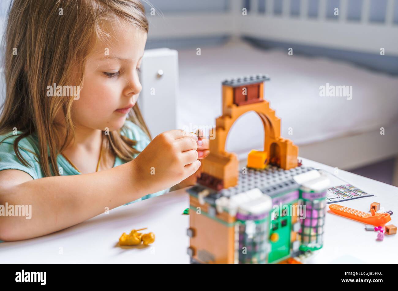 Girls, sisters play kids constructor, build house Lego Harry Potter ...