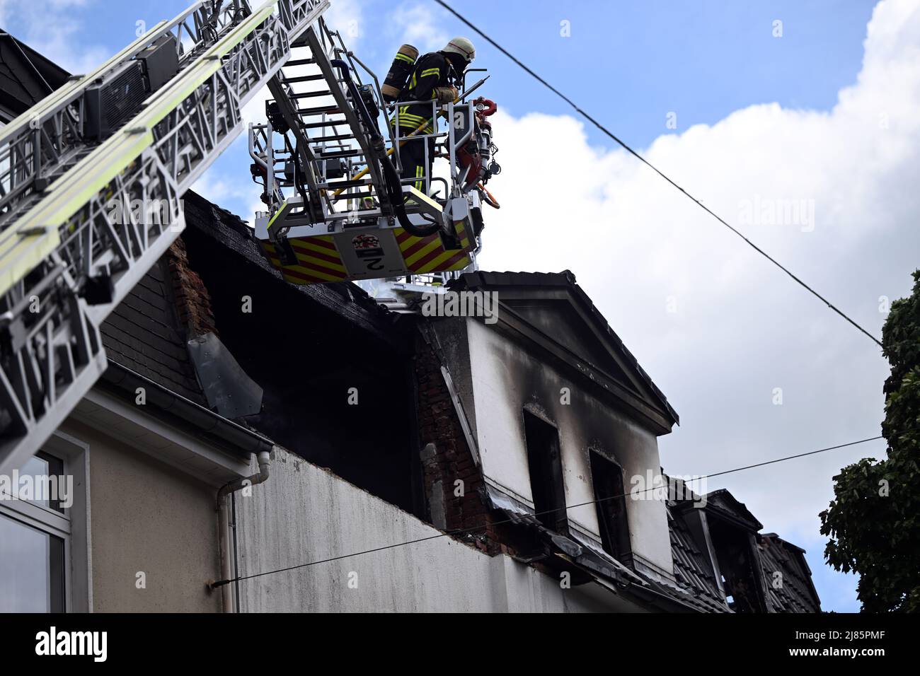 Leverkusen, Germany. 13th May, 2022. Firefighters extinguish a fire in ...